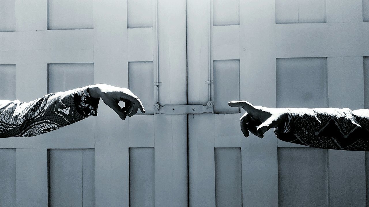 Cropped image of men hands against wall | ID: 65454467