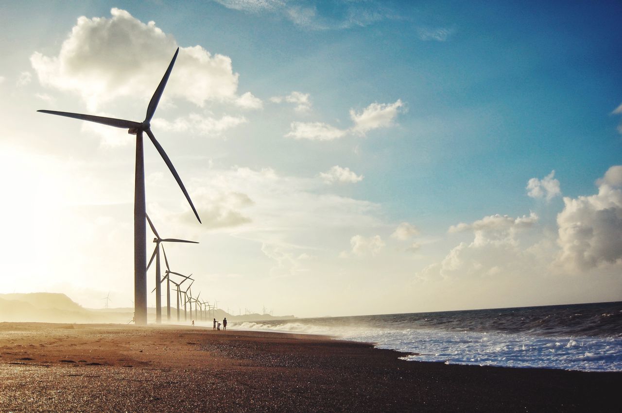 Wind turbines on beach against the sky | ID: 95778721