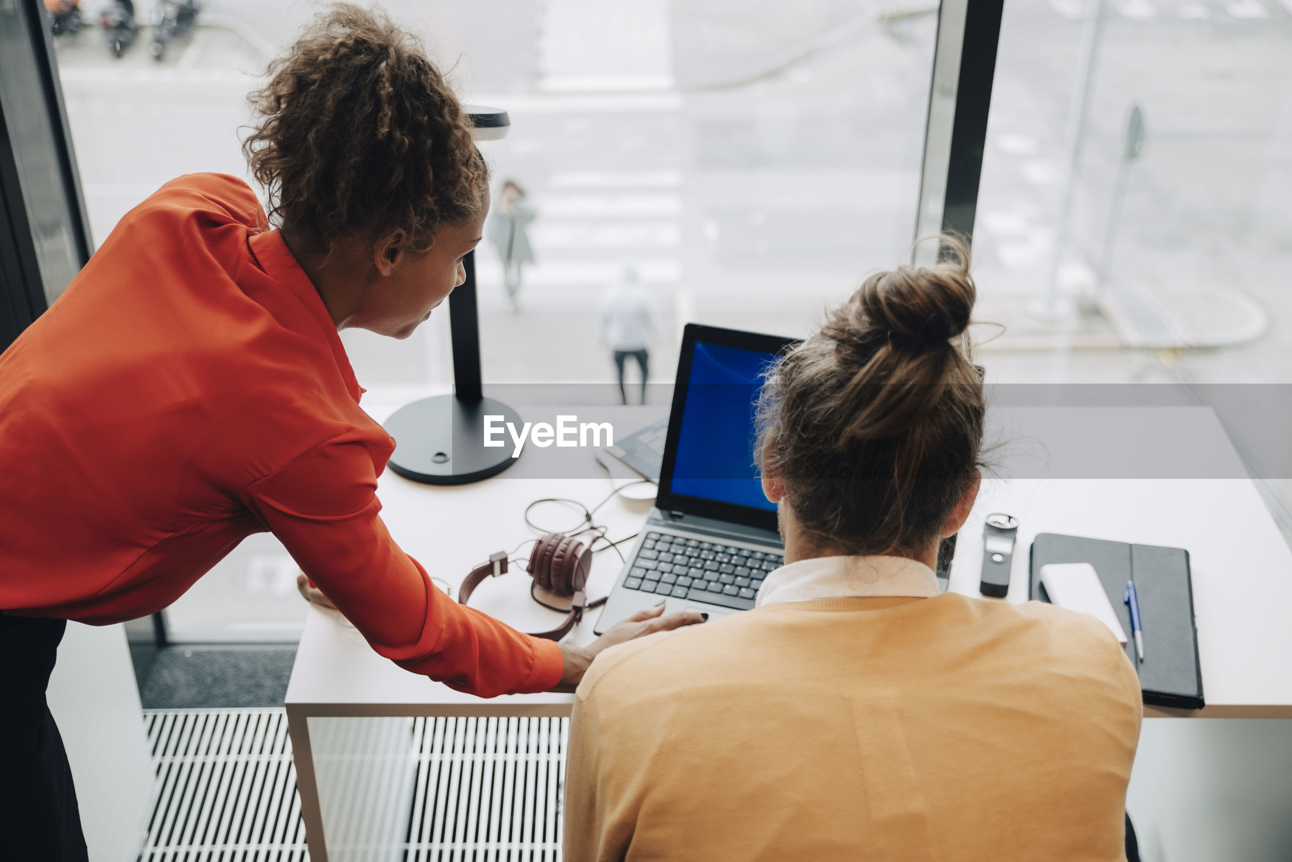 Rear view of people working in office | ID: 156764500