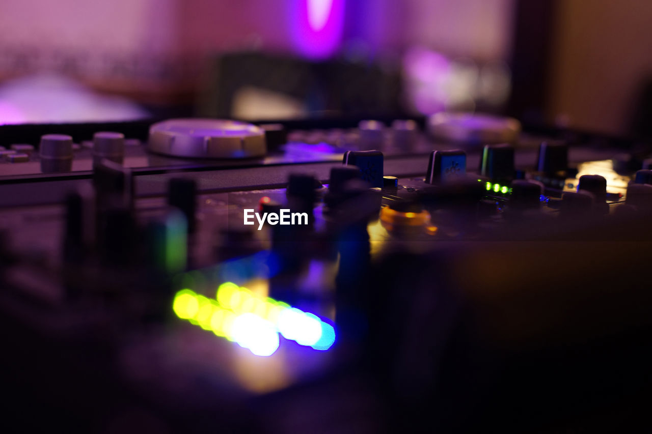 Close-up of illuminated dj mixing board | ID: 65044575