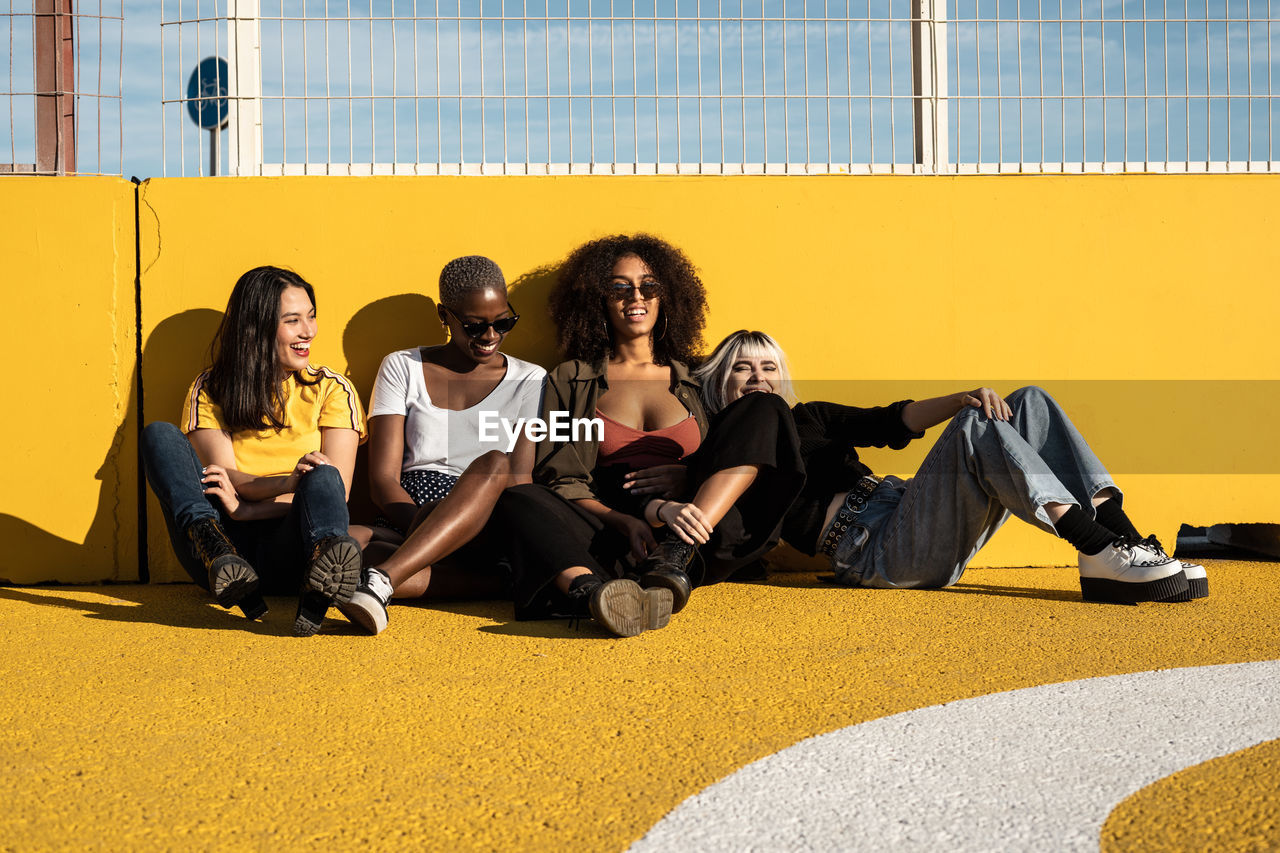 Group of people sitting on yellow seat | ID: 169452711
