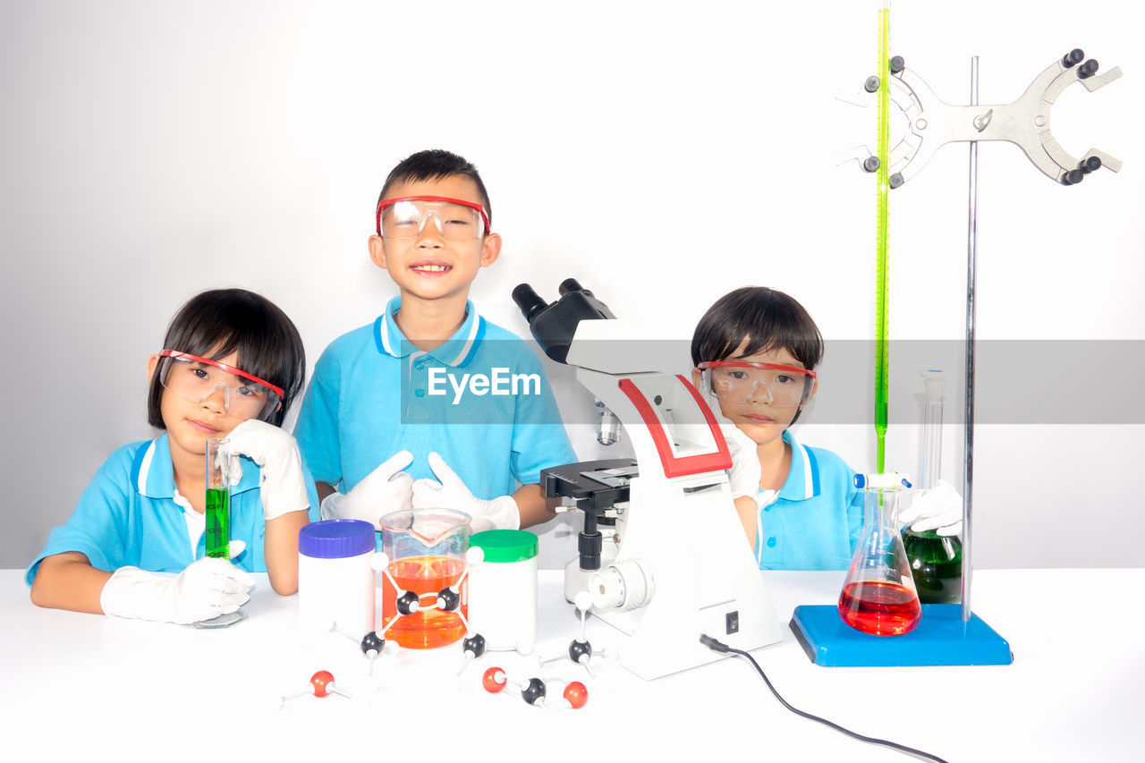 Portrait of friends doing scientific | ID: 123833657