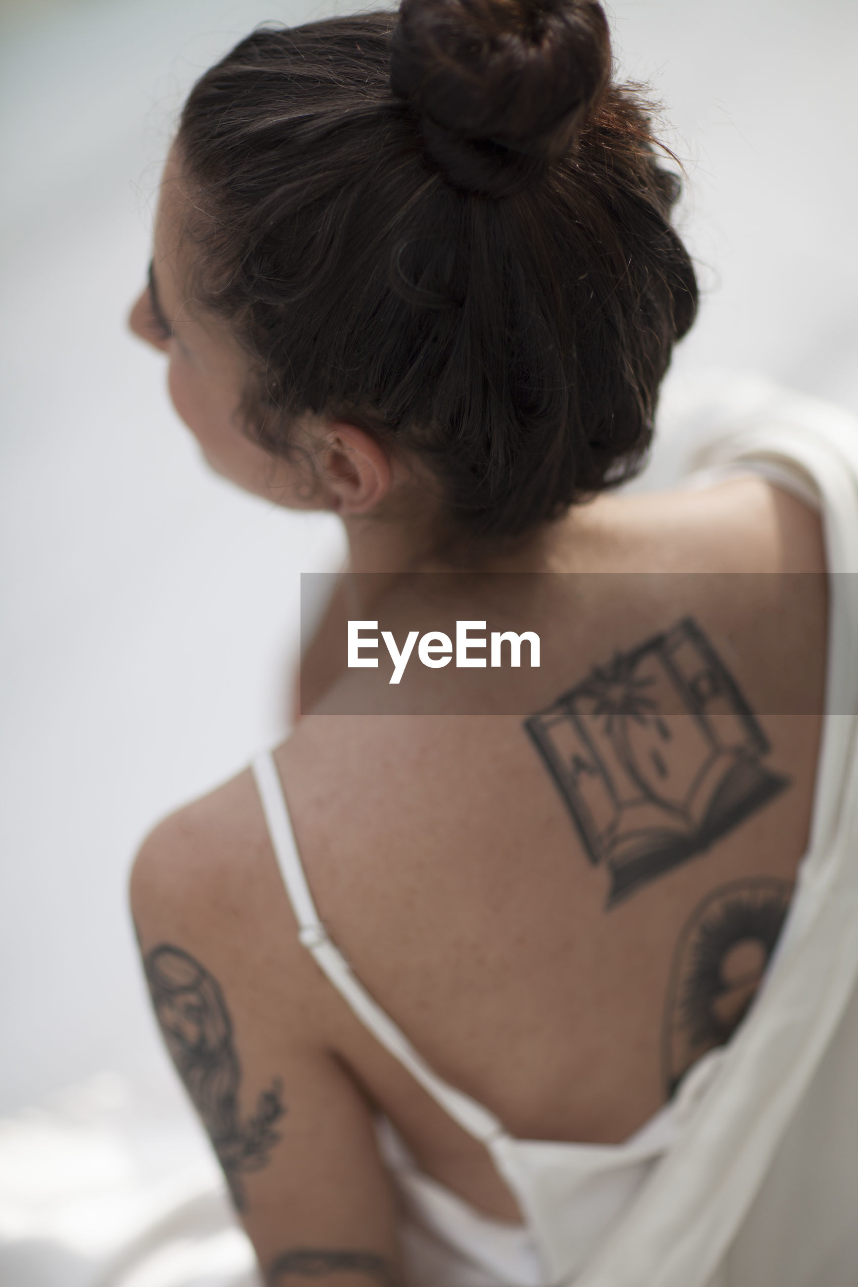 Rear view of young woman with tattoo | ID: 148239265
