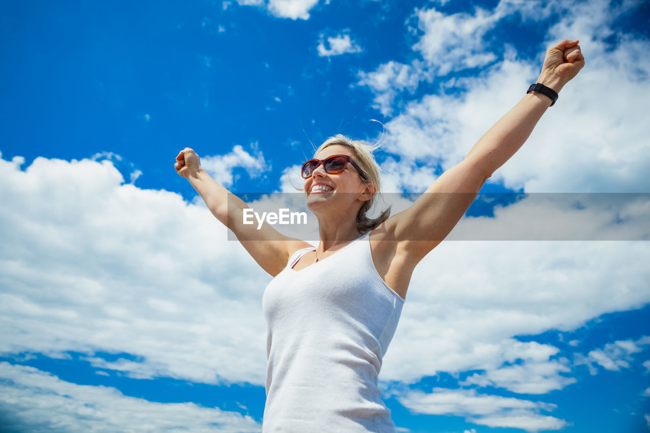Low angle view of woman standing against sky | ID: 120600026