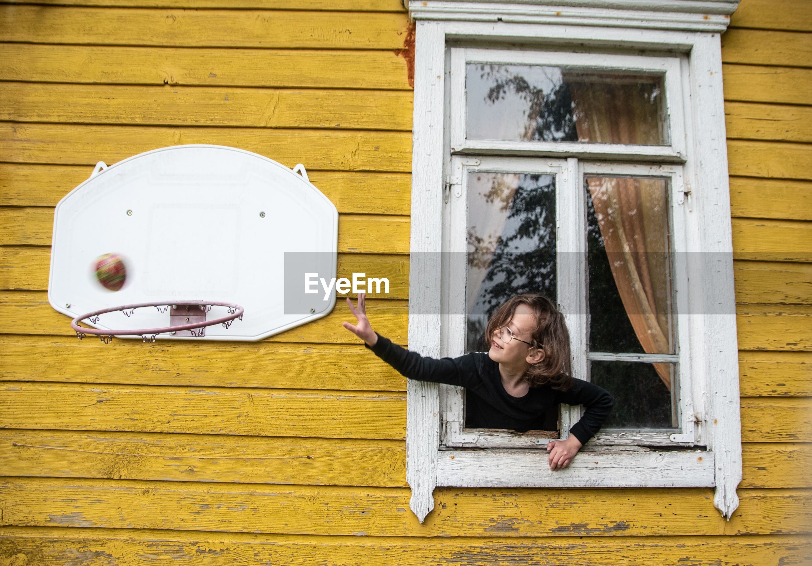 Kid playing with the ball through the window | ID: 152801079