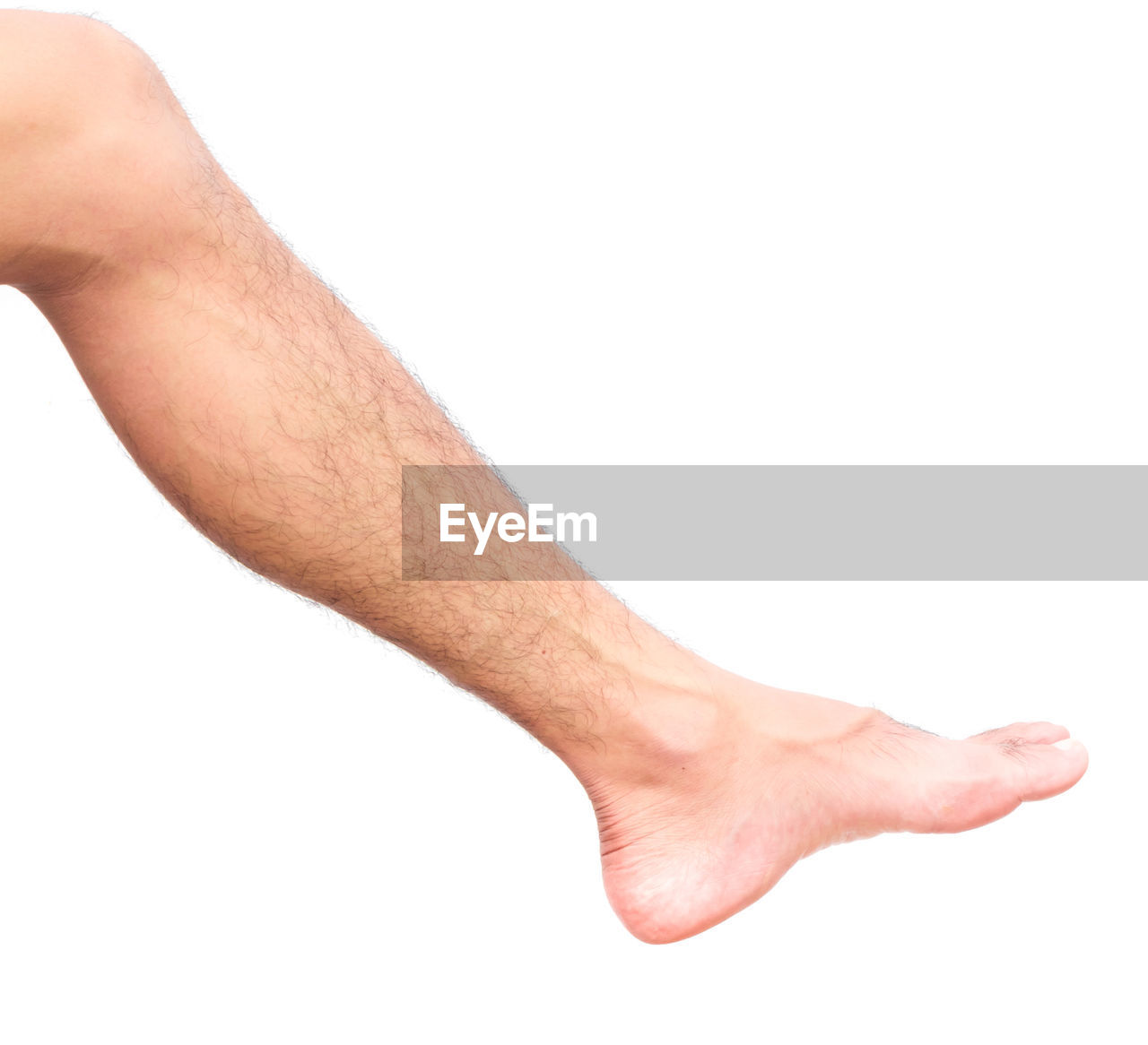Cropped leg of man against white background | ID: 103920132