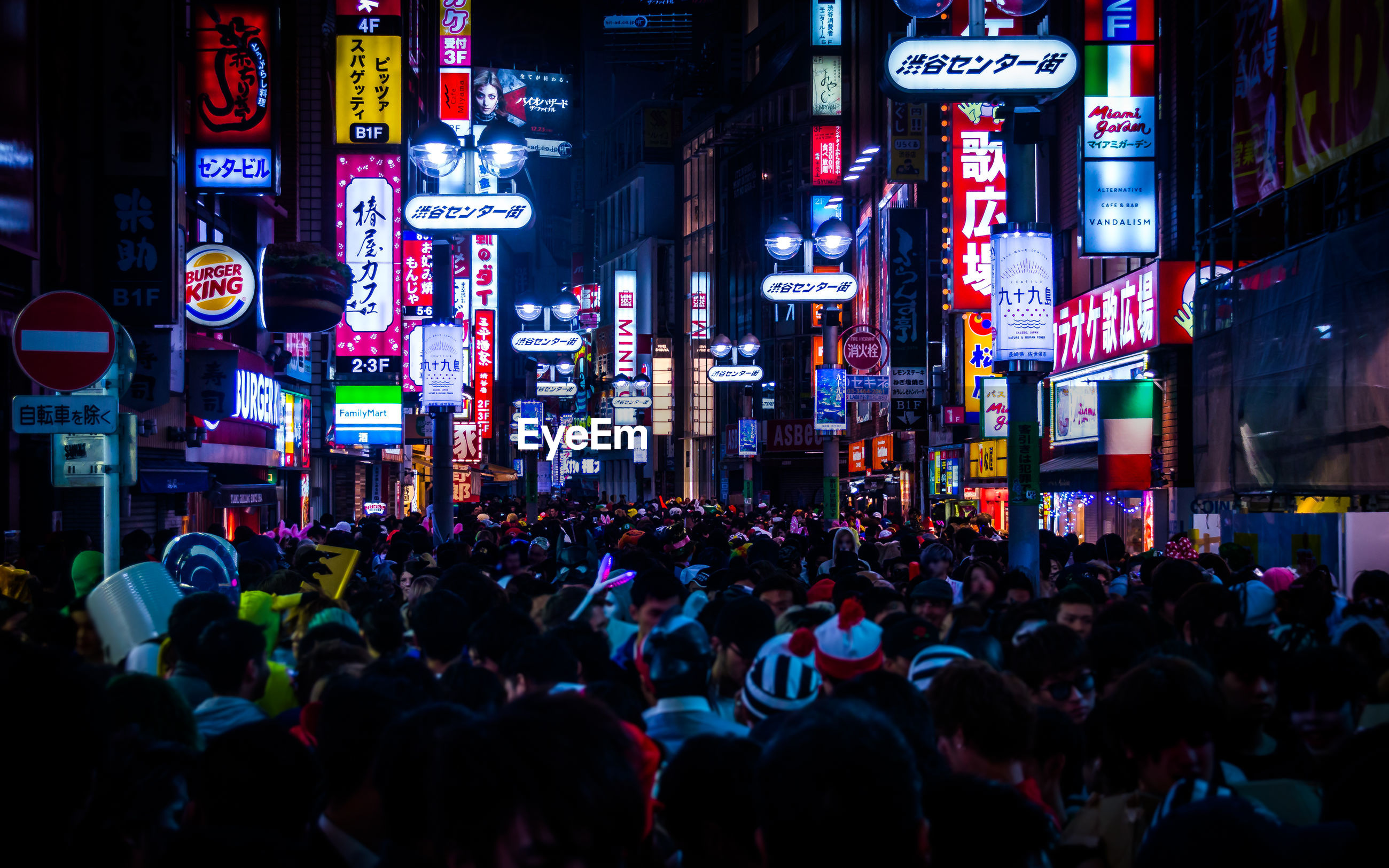 Crowd amidst illuminated billboards on | ID: 96170204