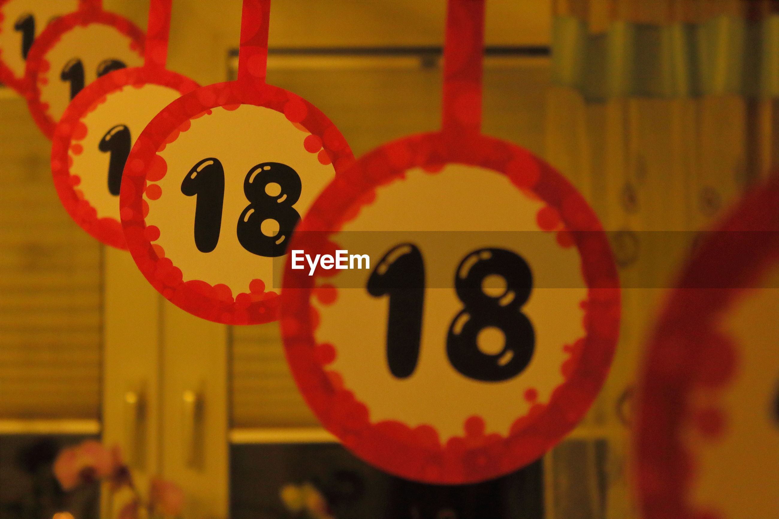 Close-up of numbers hanging indoors | ID: 116094797