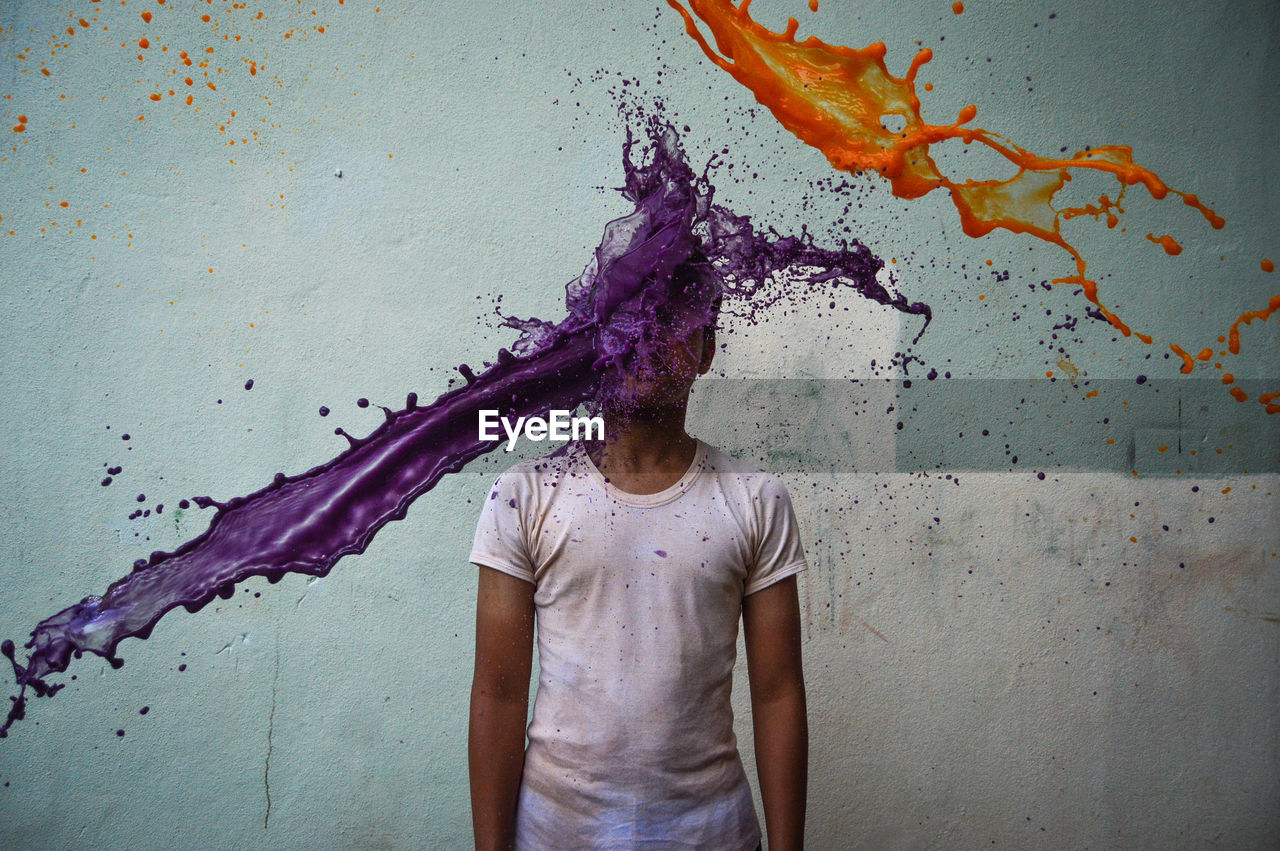 Close-up of paint splashing over man | ID: 105158808