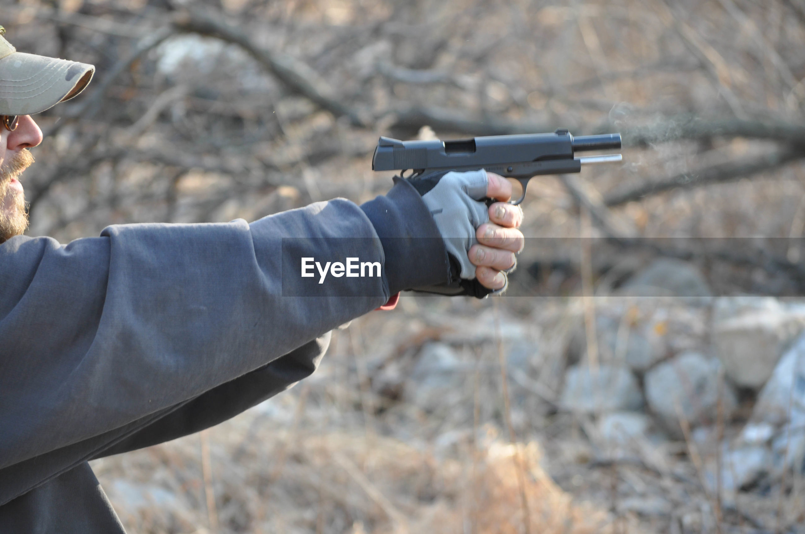Close-up of man aiming pistol | ID: 118586405