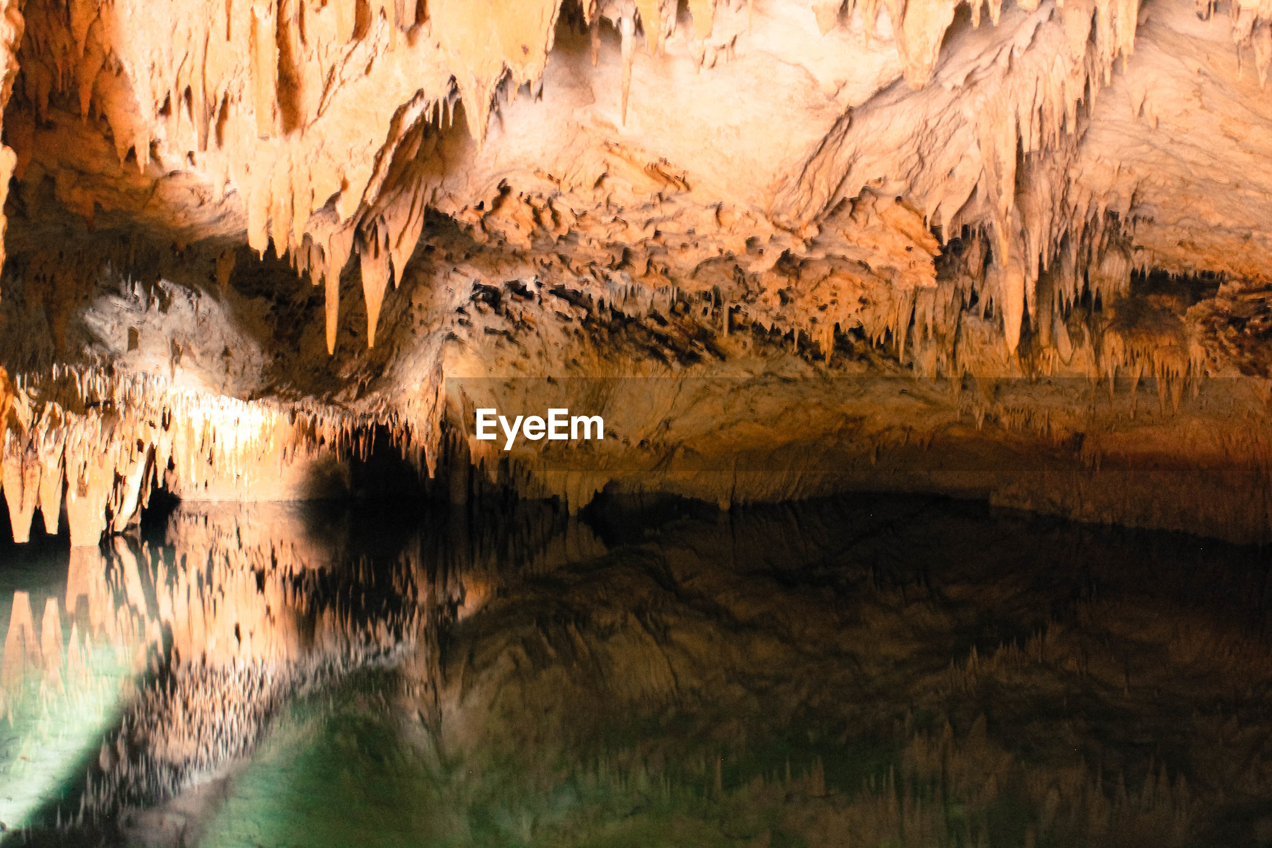 Reflection of cave on water in river | ID: 111011278
