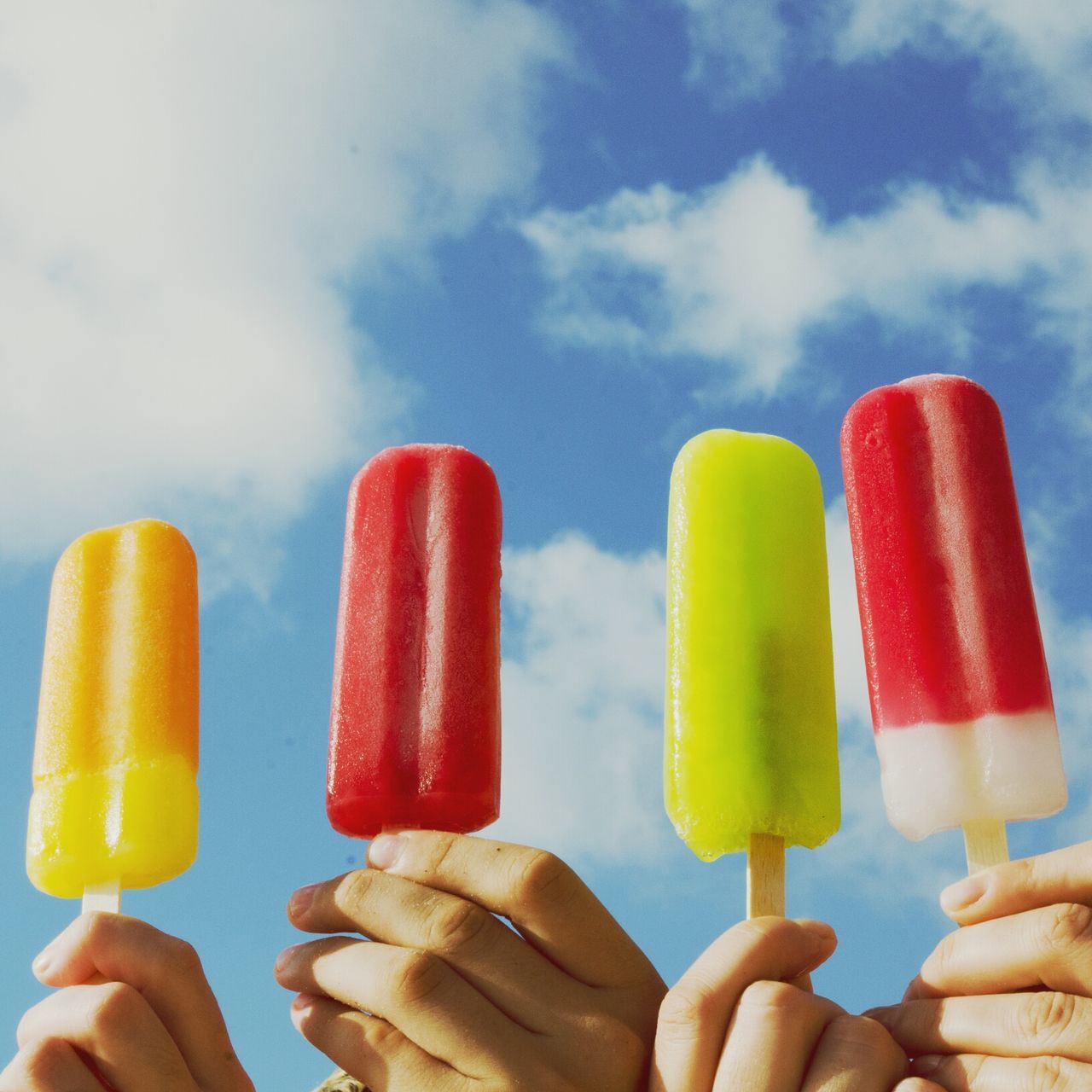 Cropped image of people holding popsicles | ID: 42810945